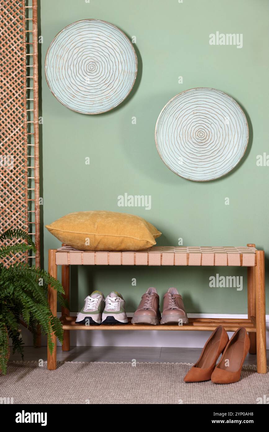 Stylish hallway interior with bench and folding screen Stock Photo - Alamy