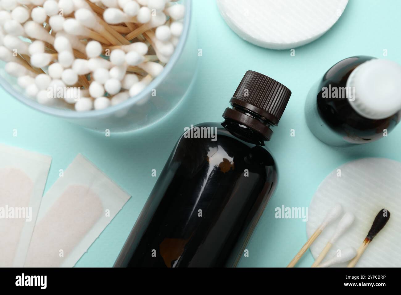 Topical iodine and other first aid kit components on light blue ...