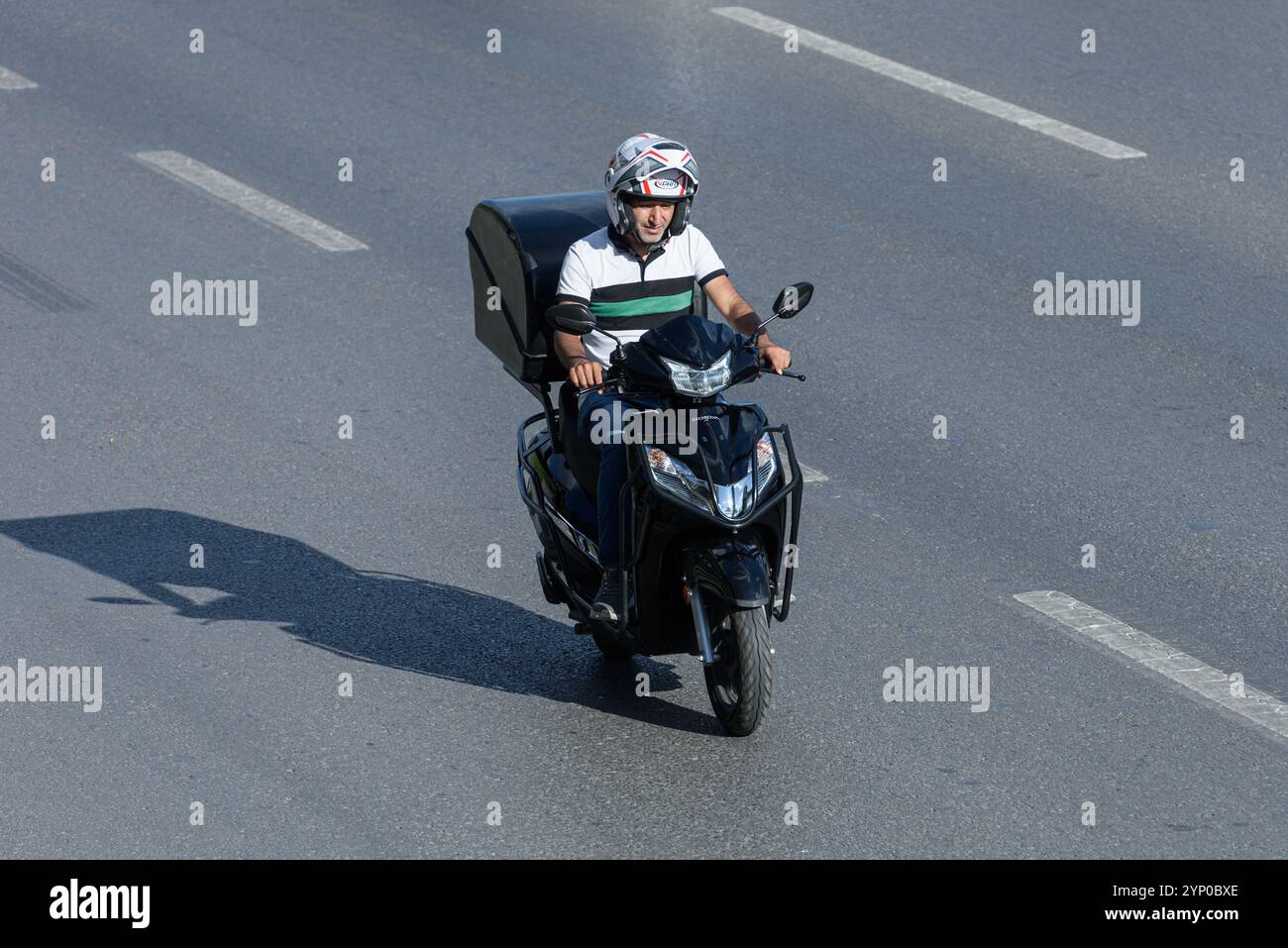 ISTANBUL, TURKEY - NOVEMBER 24, 2024: Man from city riding motorcycle ...