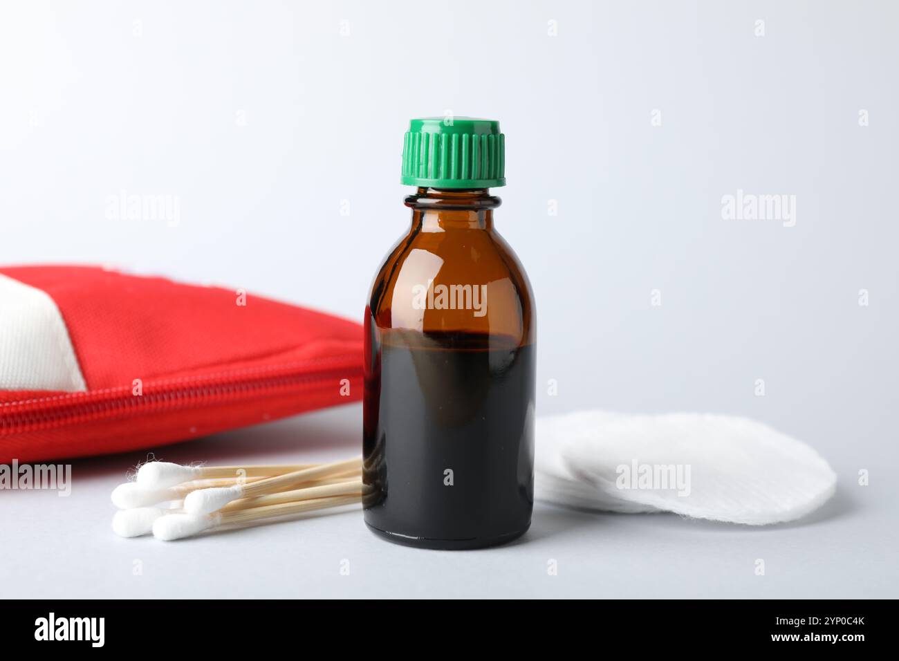 Topical iodine and other first aid kit components on light background ...