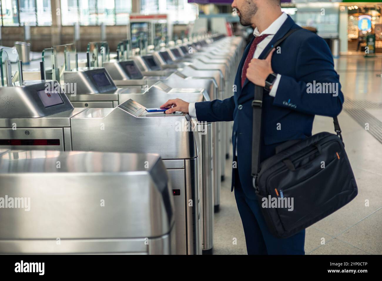 unrecognizable businessman with a briefcase uses his smartphone to make ...