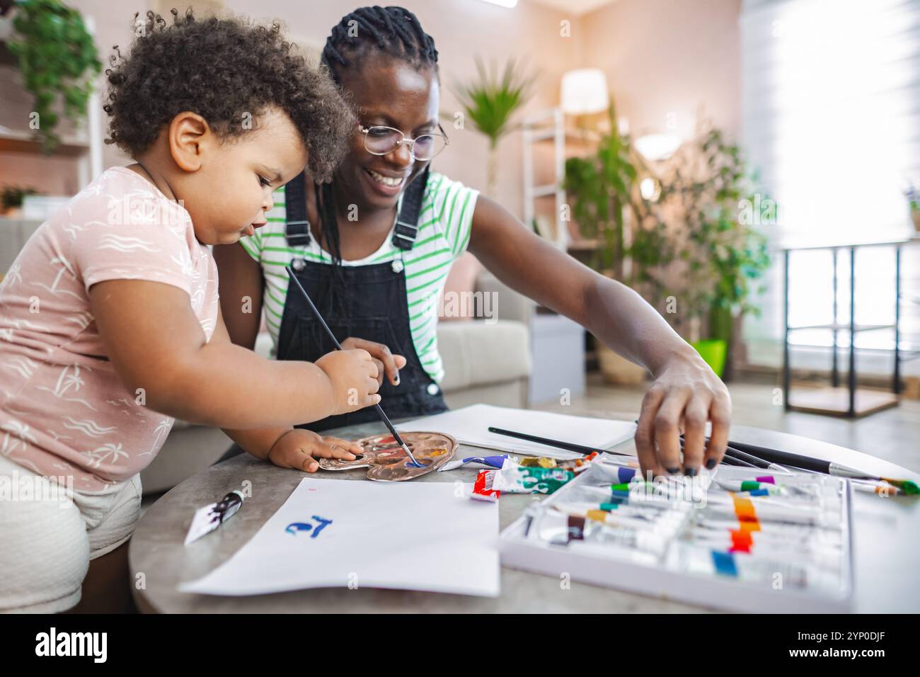 Joyful painting moments in the living room Stock Photo - Alamy