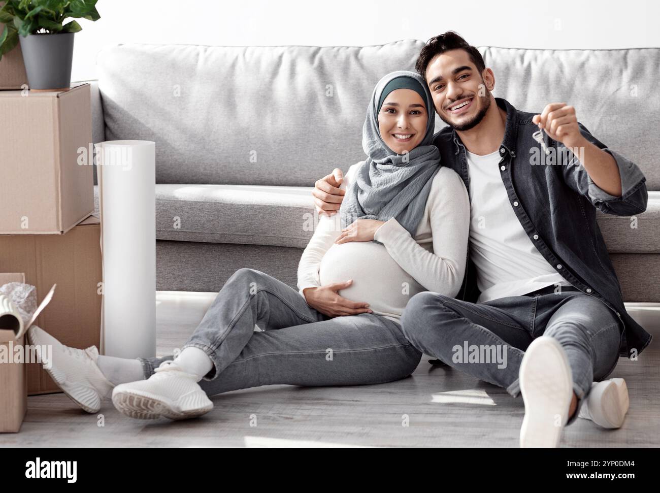Loving expecting family showing key from new apartment Stock Photo - Alamy