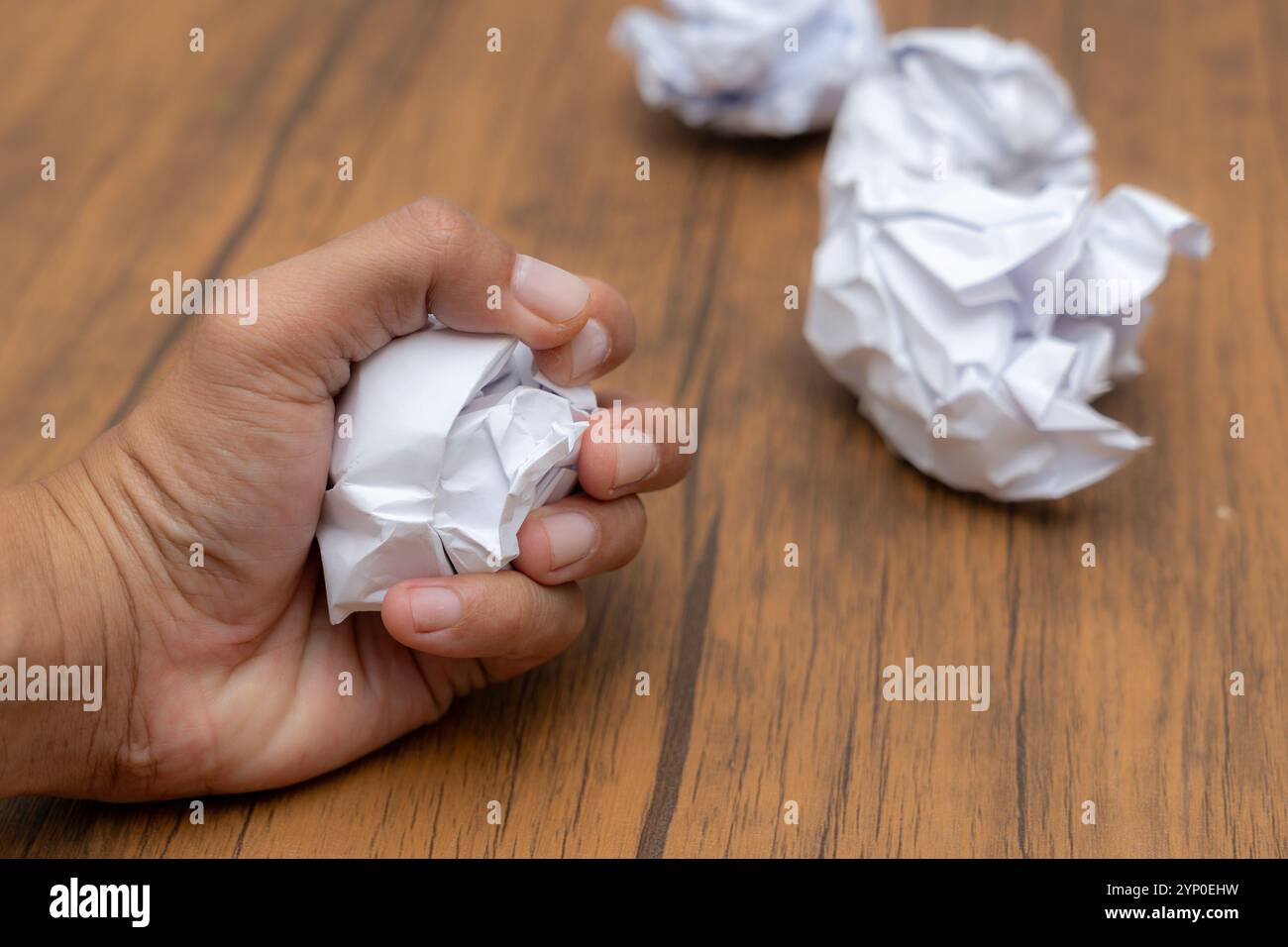 Writing concept - crumpled up paper wads with a sheet of white paper ...
