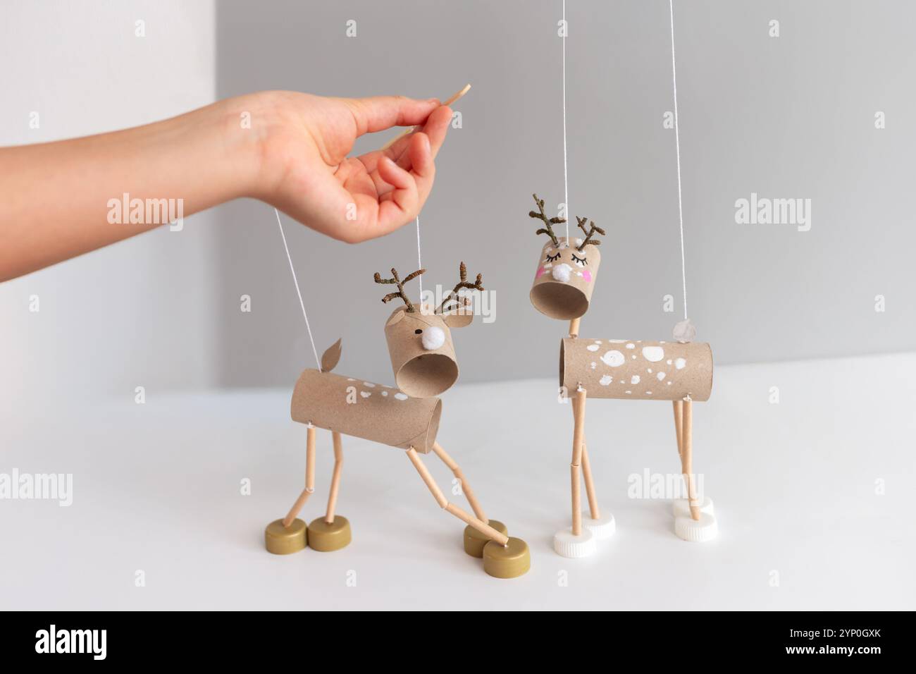 Festive DIY reindeer puppets made from cardboard tubes and bottle caps ...