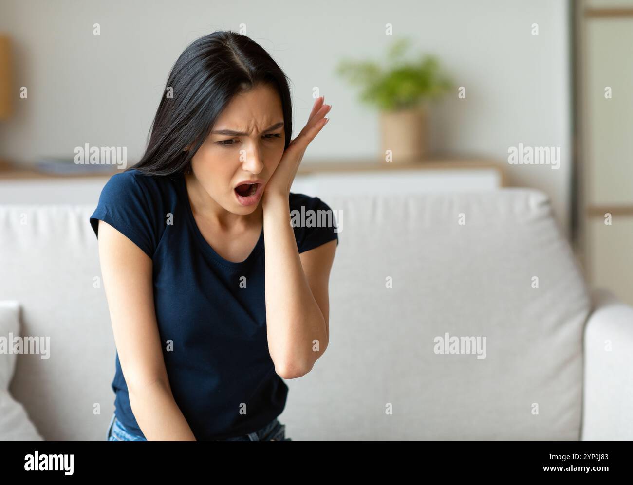 Girl Suffering From Tooth Pain Touching Cheek Sitting At Home Stock ...