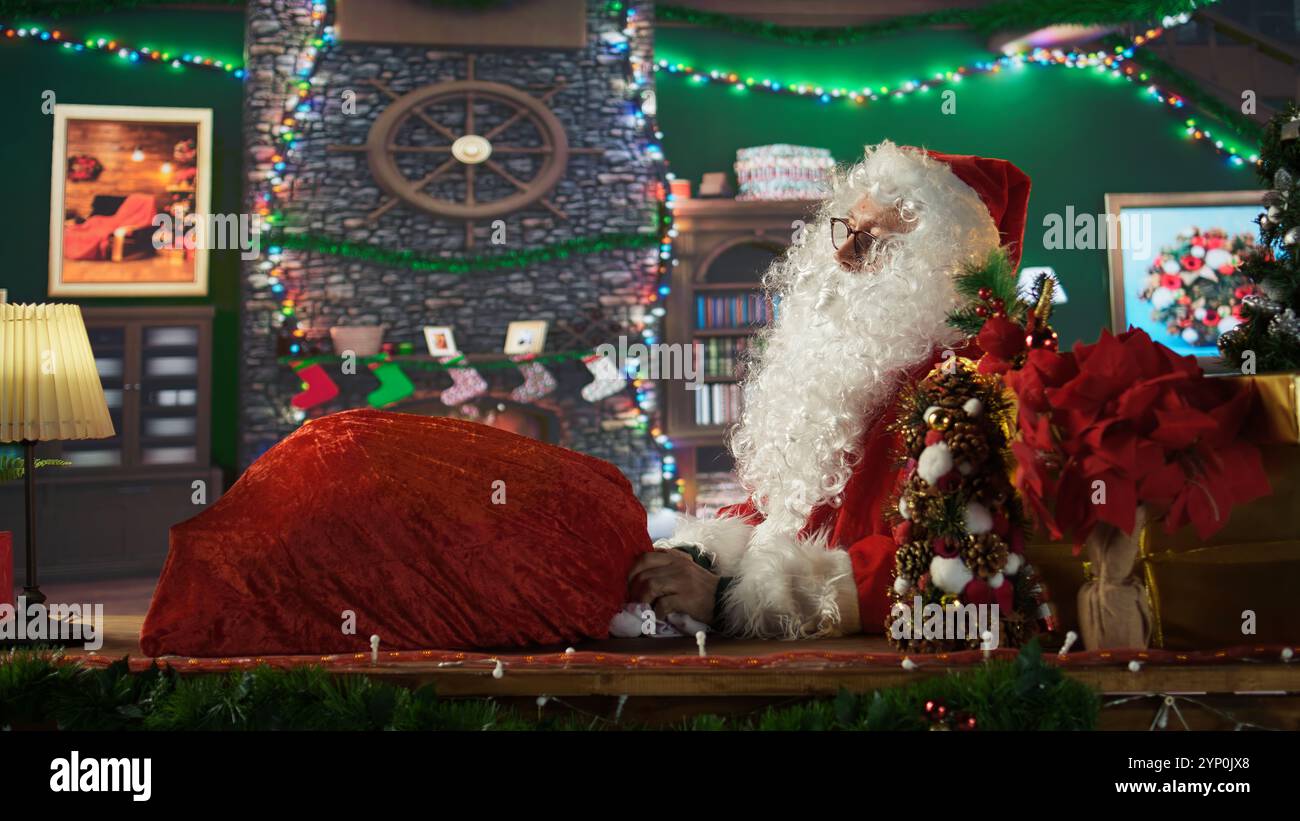 Senior man Saint Nick taking his sack full of gifts and starting his ...