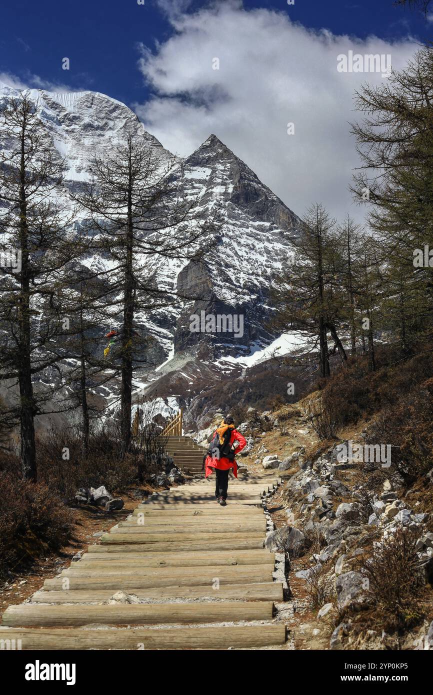Lost in the beauty of Yading's majestic peaks, a young adventurer ...