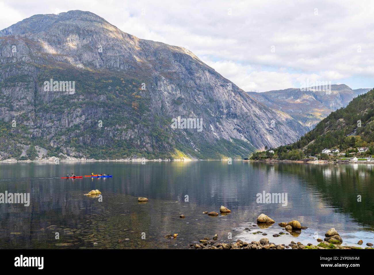 Eidfjord Norway, tour group in kayaks paddle on the fjord, Eidfjord is ...