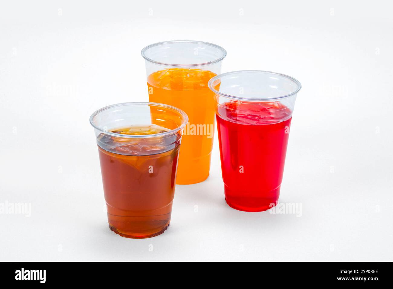 Three clear cups with juice, soda pop and ice tea Stock Photo - Alamy