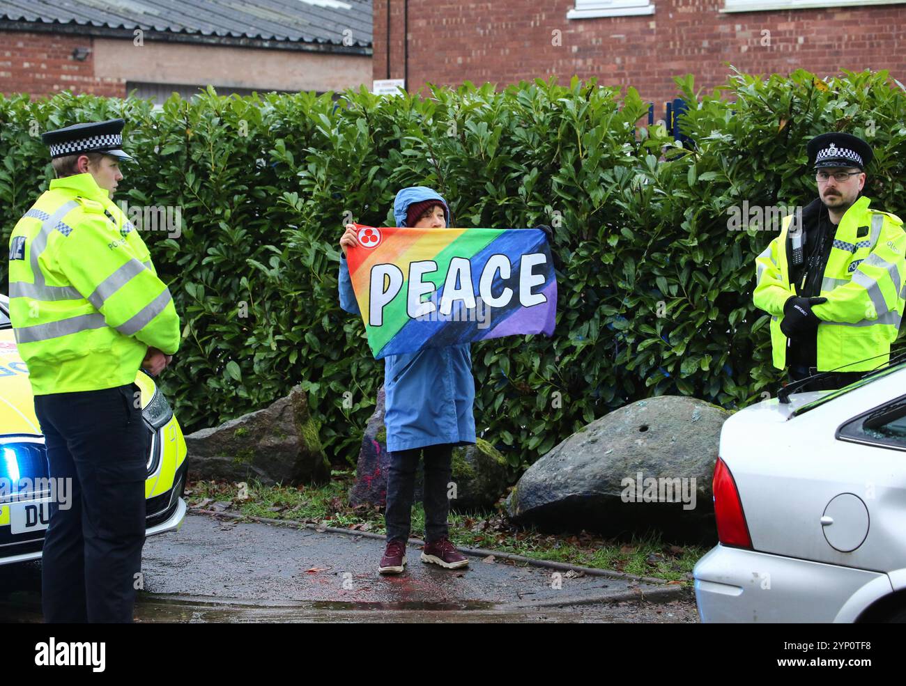 A supporter of the activists holds a placard saying ëPeaceí outside the ...
