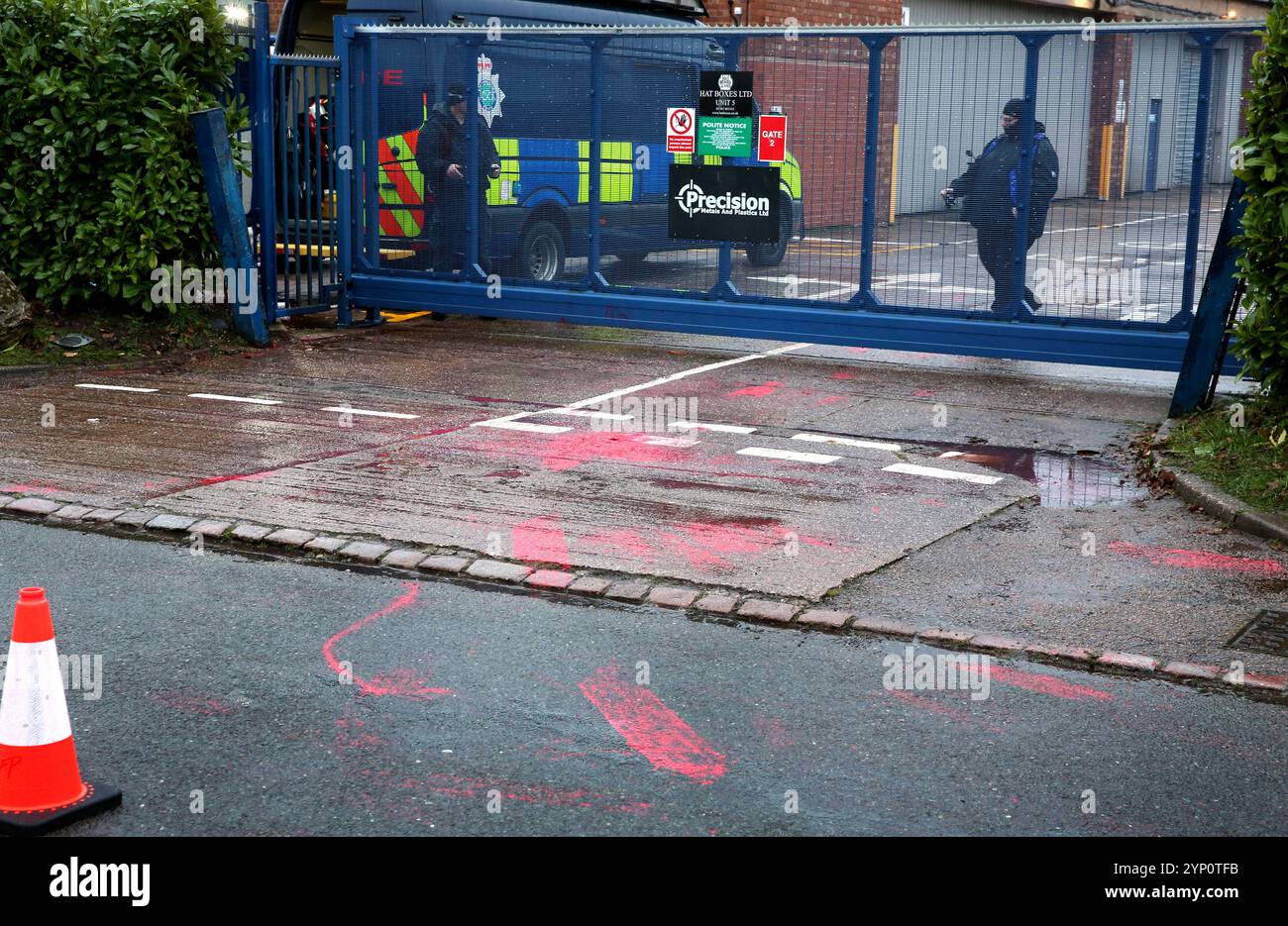 Paint remnants are left on the road at the main gate after the car ...