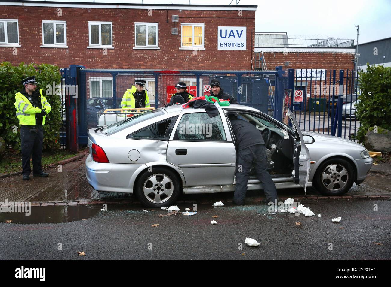 Police officers go about releasing two activists locked inside a car ...