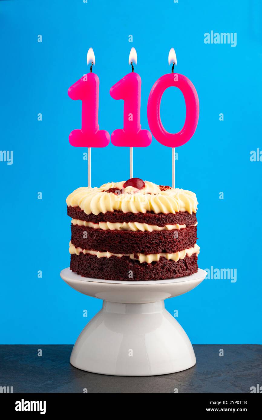 Red velvet birthday cake with number 110 candle Stock Photo - Alamy