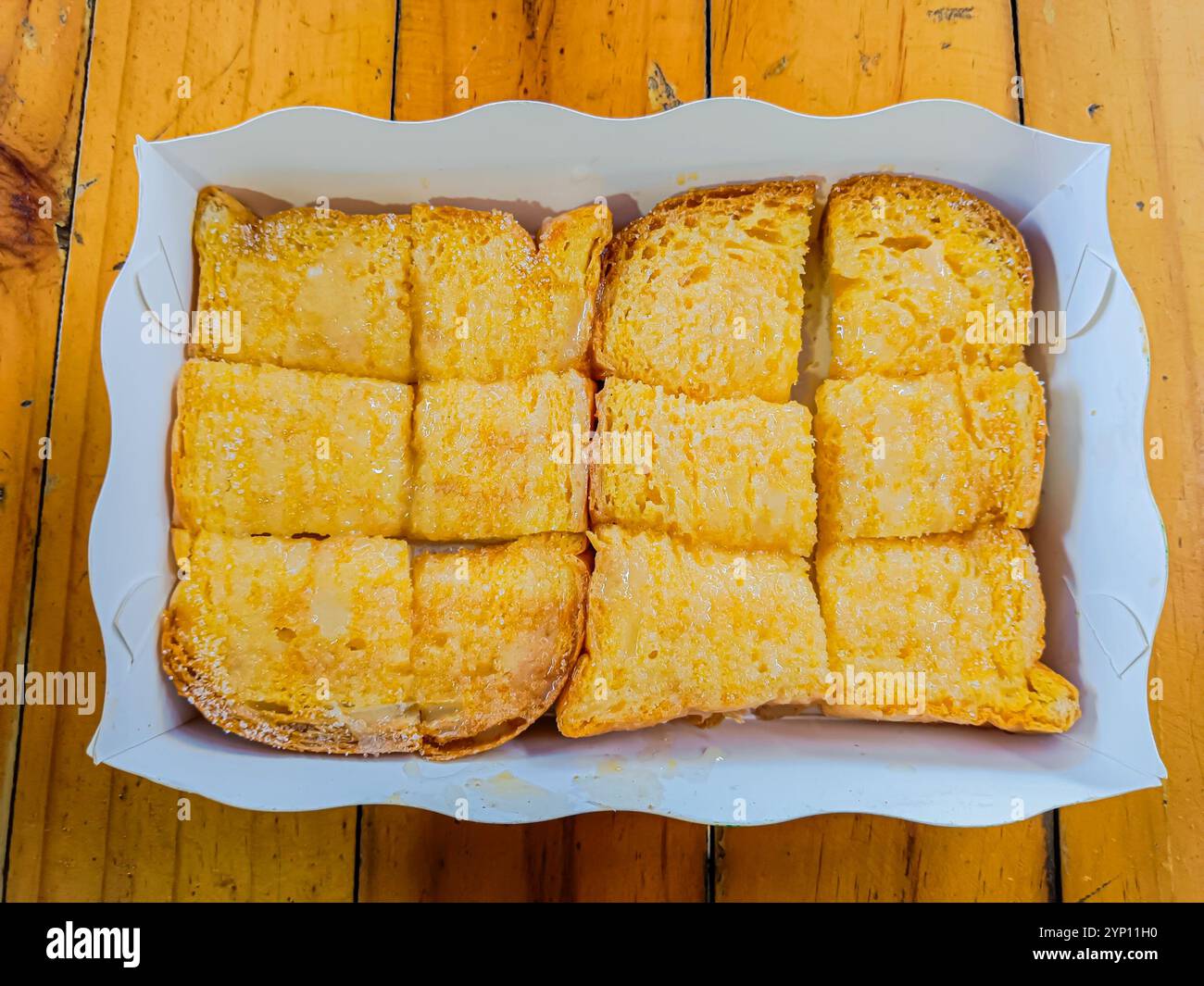 Grilled butter toast, golden brown crispy bread topped with sugar and ...