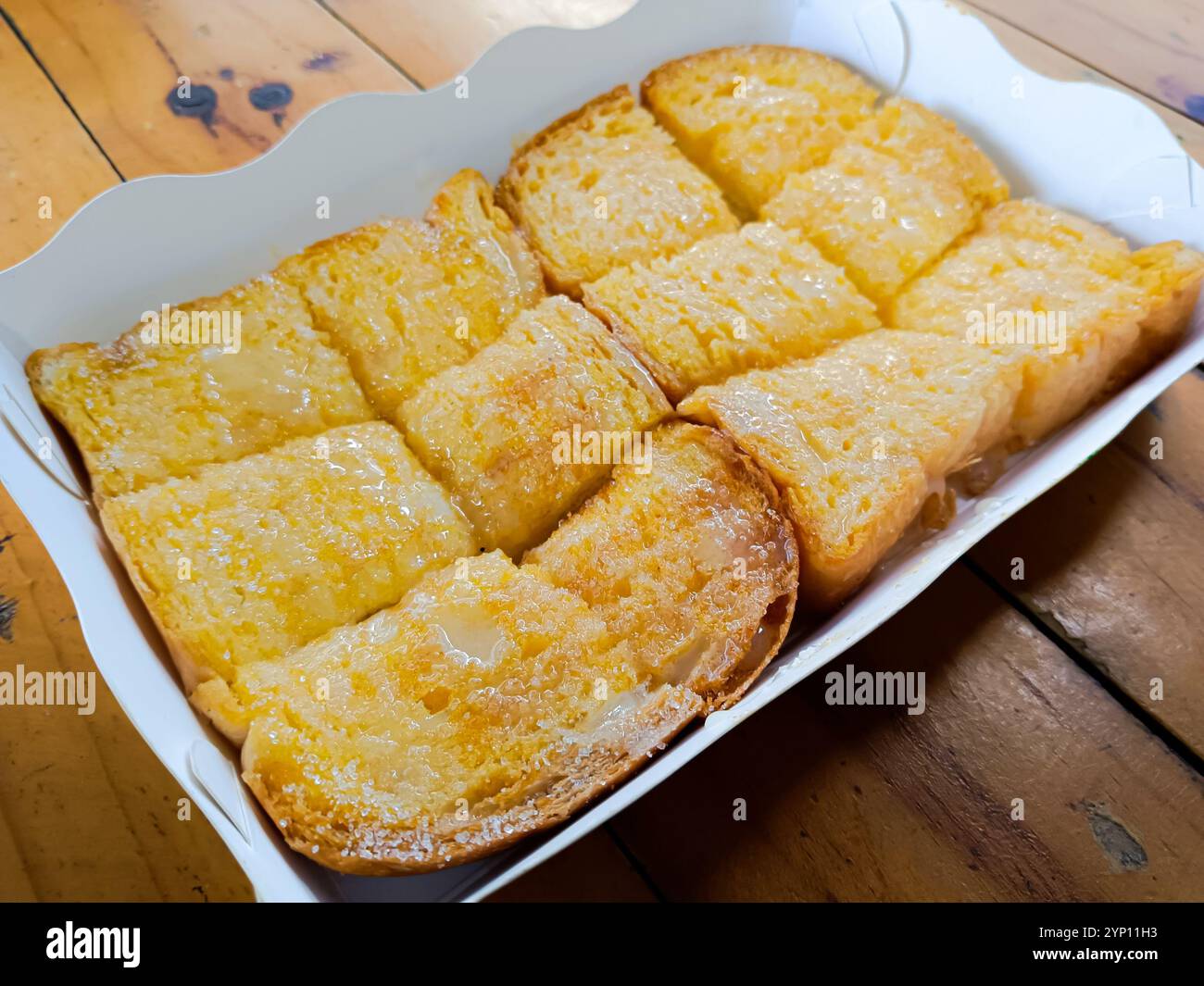 Grilled butter toast, golden brown crispy bread topped with sugar and ...
