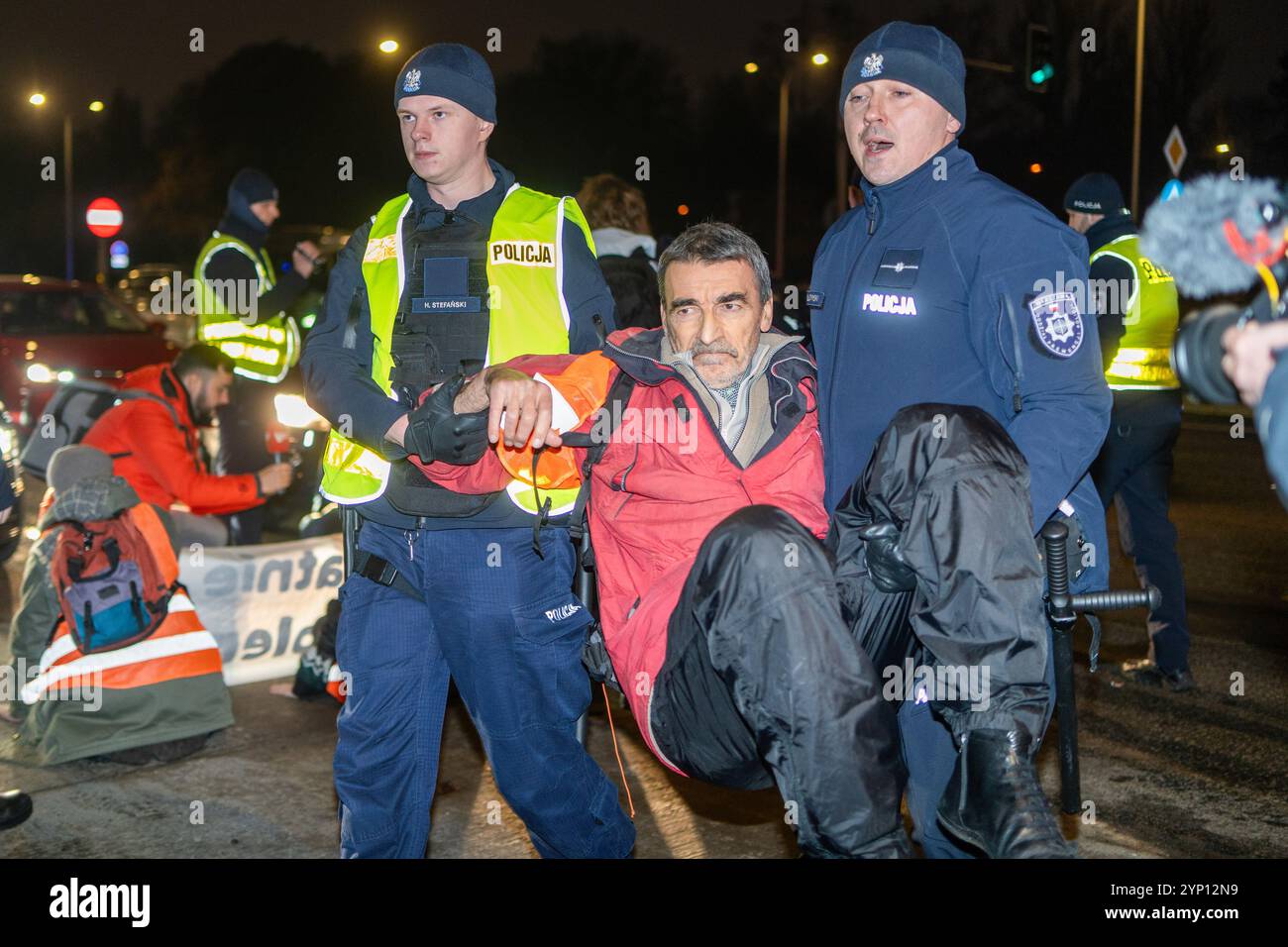 Police officers remove a protester from the road during the ...