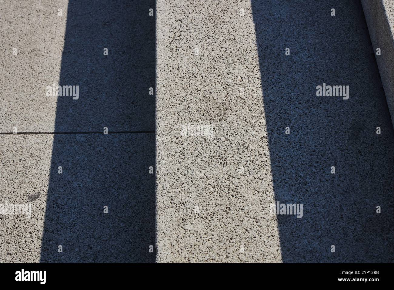 Concrete steps of a staircase made of gray blocks close up. Straight ...