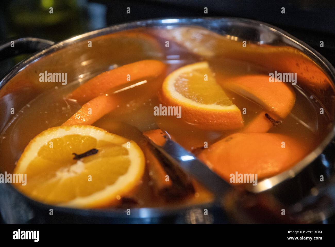 Spiced Apple Cider simmering on the stove Stock Photo - Alamy