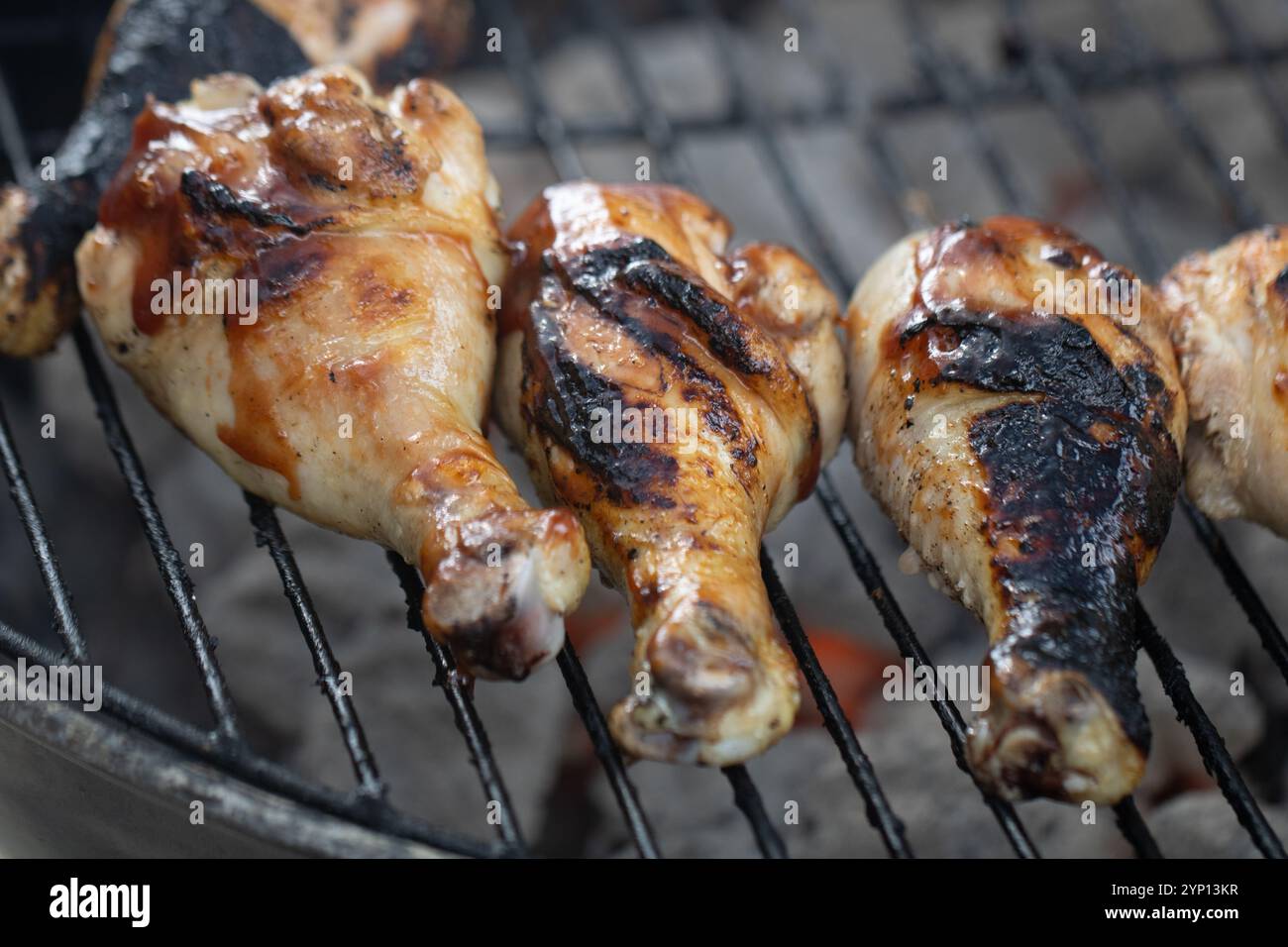 Cooking BBQ Chicken Legs on the grill Stock Photo - Alamy