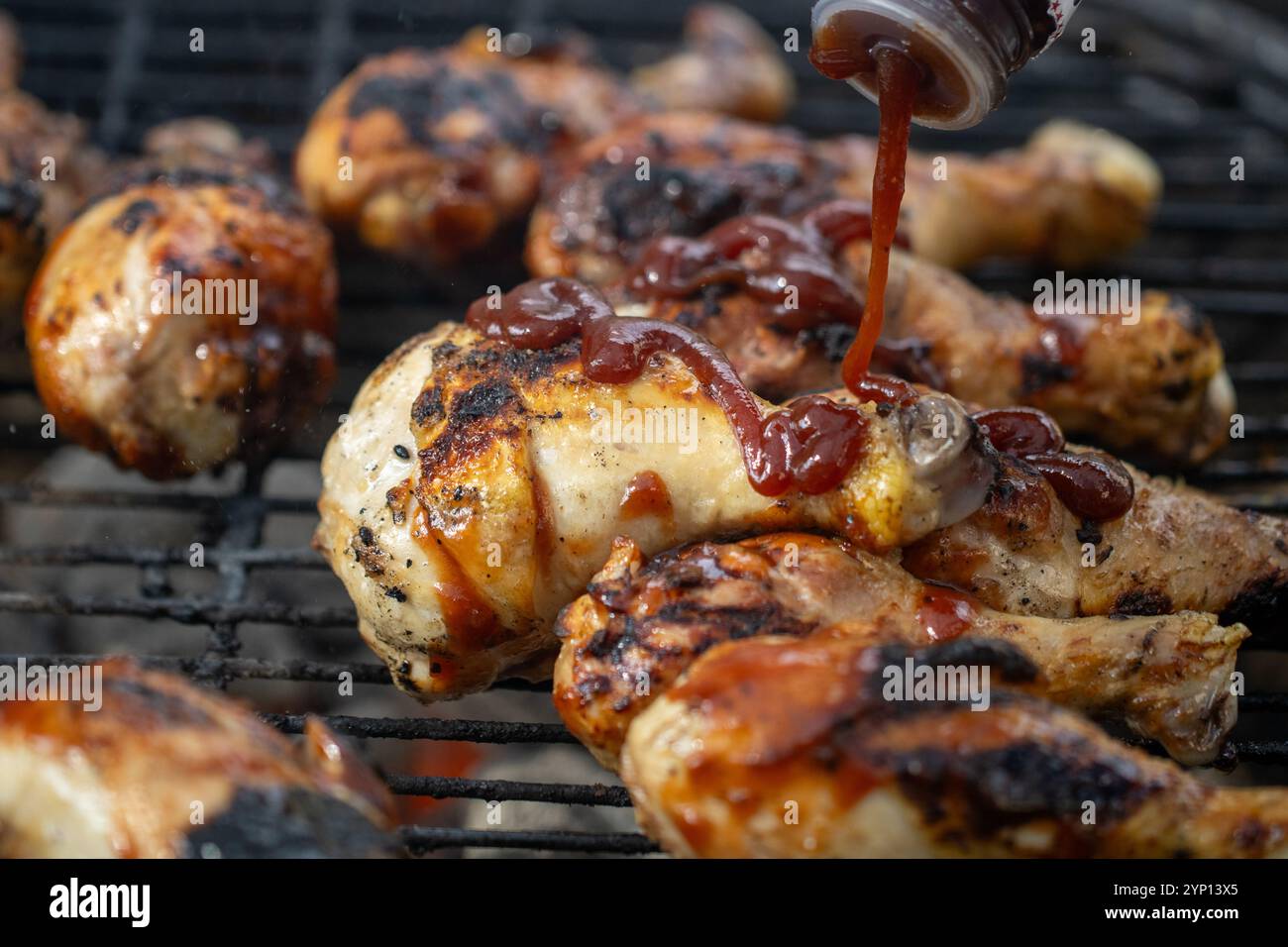 Cooking BBQ Chicken Legs on the grill Stock Photo - Alamy