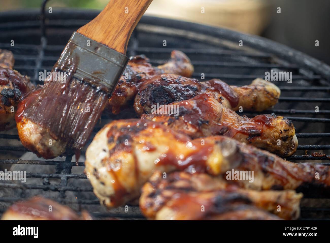 Cooking BBQ Chicken Legs on the grill Stock Photo - Alamy