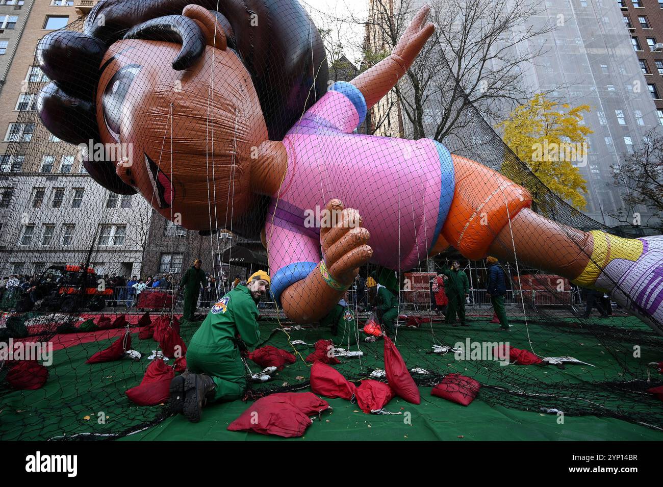 Dora the Explorer balloon is held under a net during the annual balloon ...