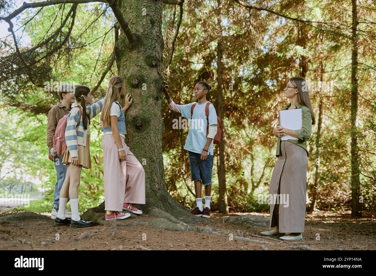 Students Touching Tree Trunk During Tour In Botanical Garden Stock ...