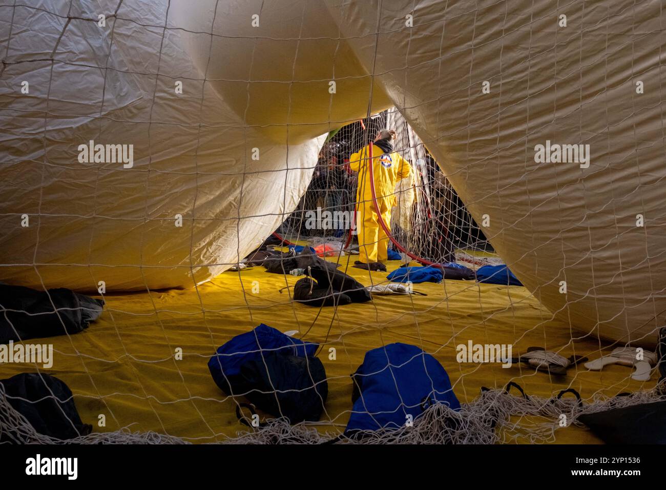A balloon worker seen under Snoopy holding an air hose. Every year ...