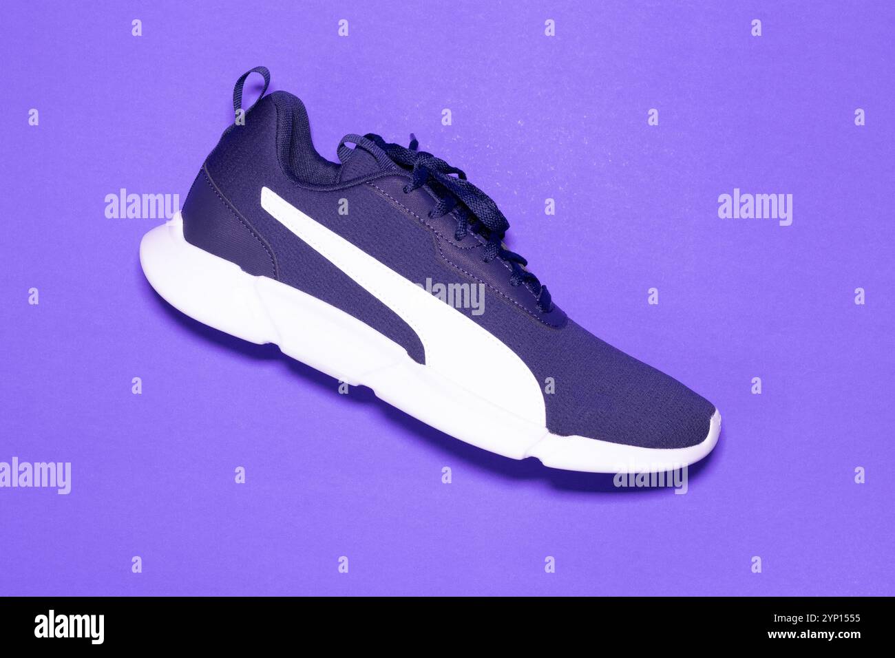 Showcasing a running shoe from side angle with a matching dark ...