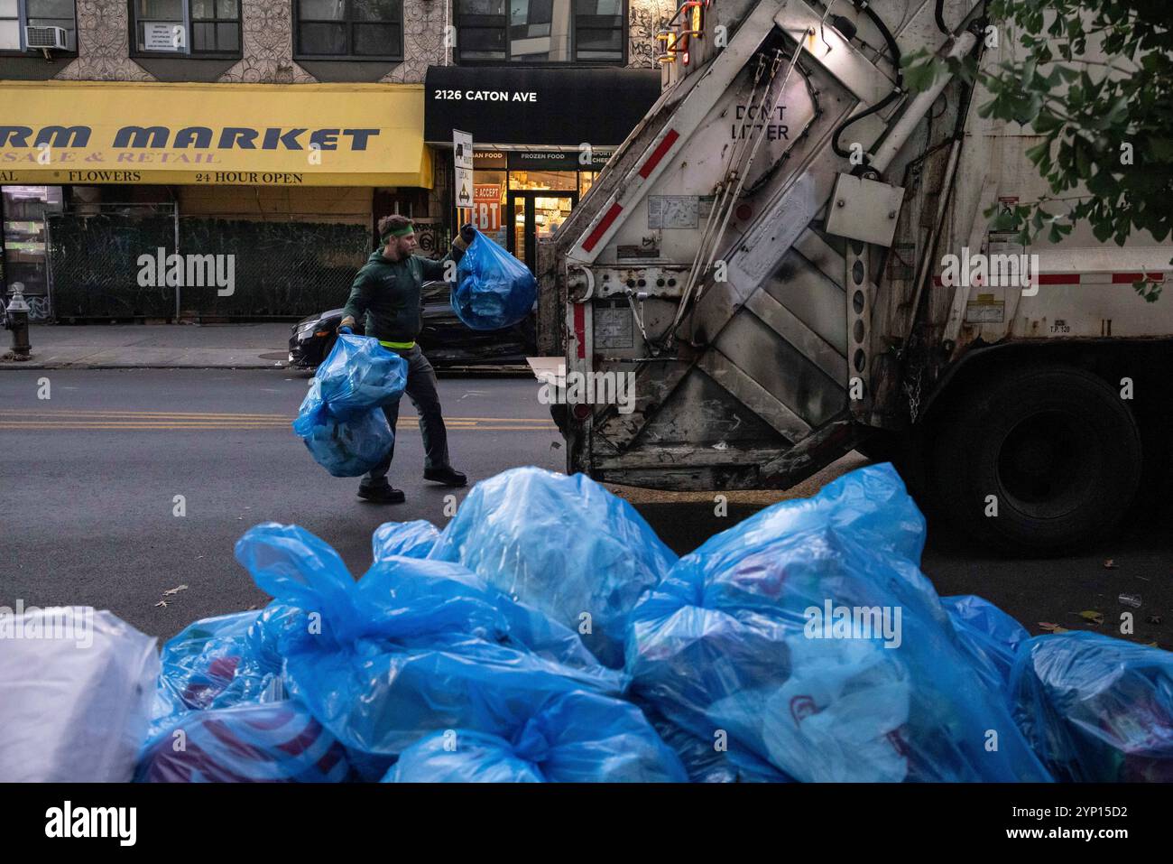 A sanitation worker collects trash, Saturday, Nov. 16, 2024, in the ...
