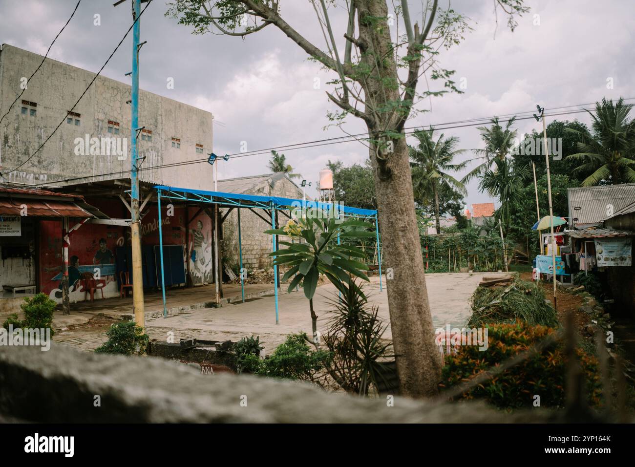 An outdoor community space with a simple sports court, blue steel ...