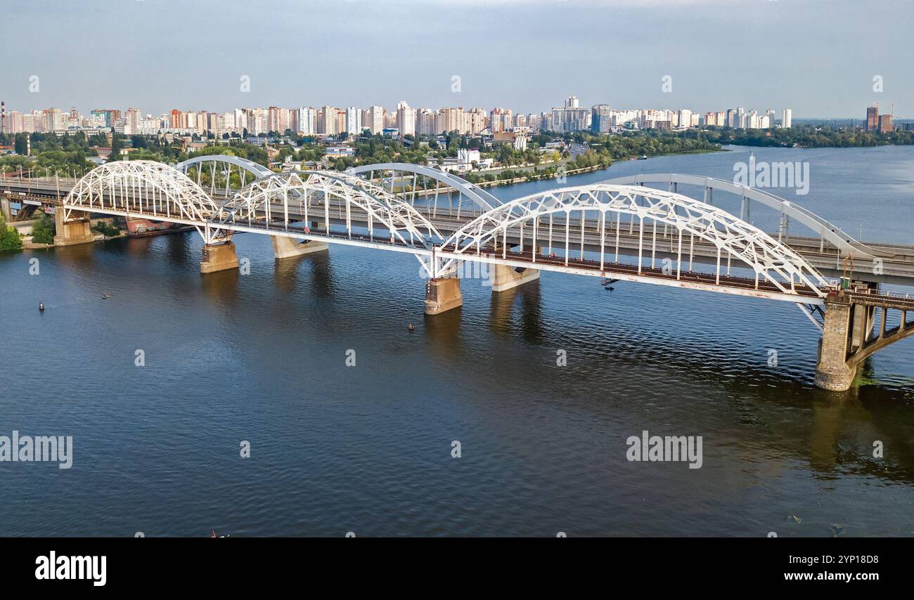Aerial top view of automobile and railroad Darnitsky bridge across ...