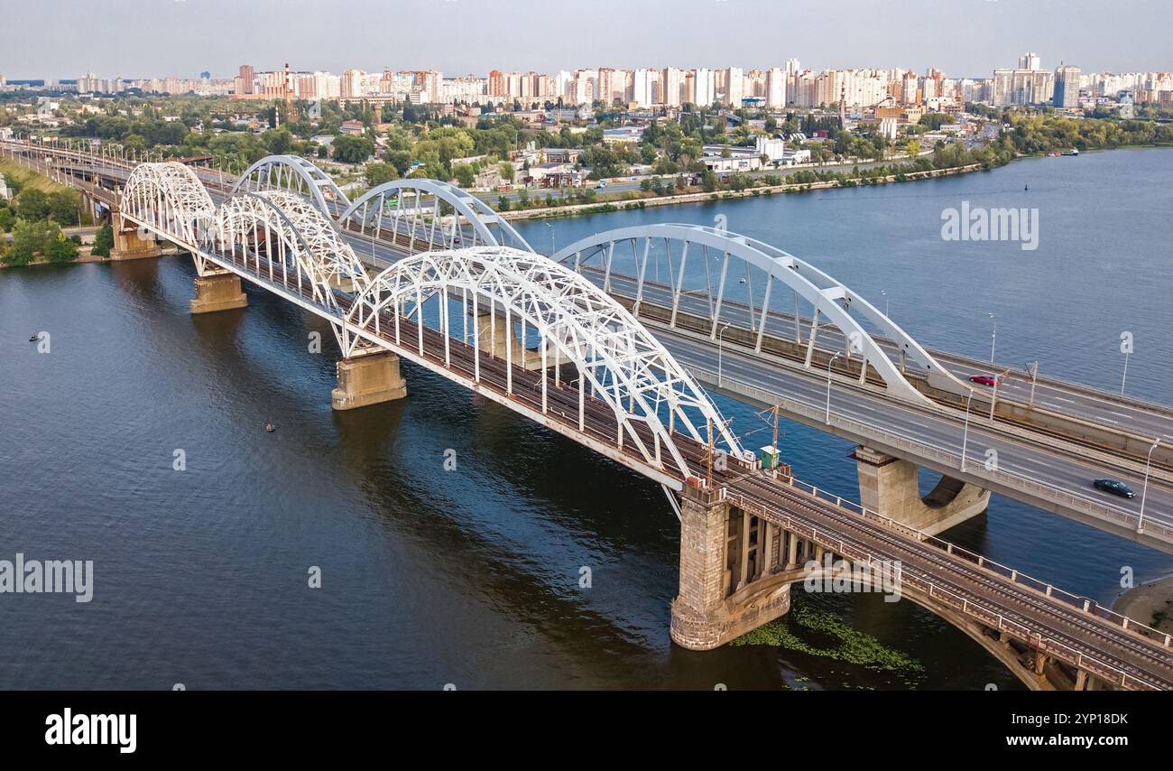 Aerial top view of automobile and railroad Darnitsky bridge across ...