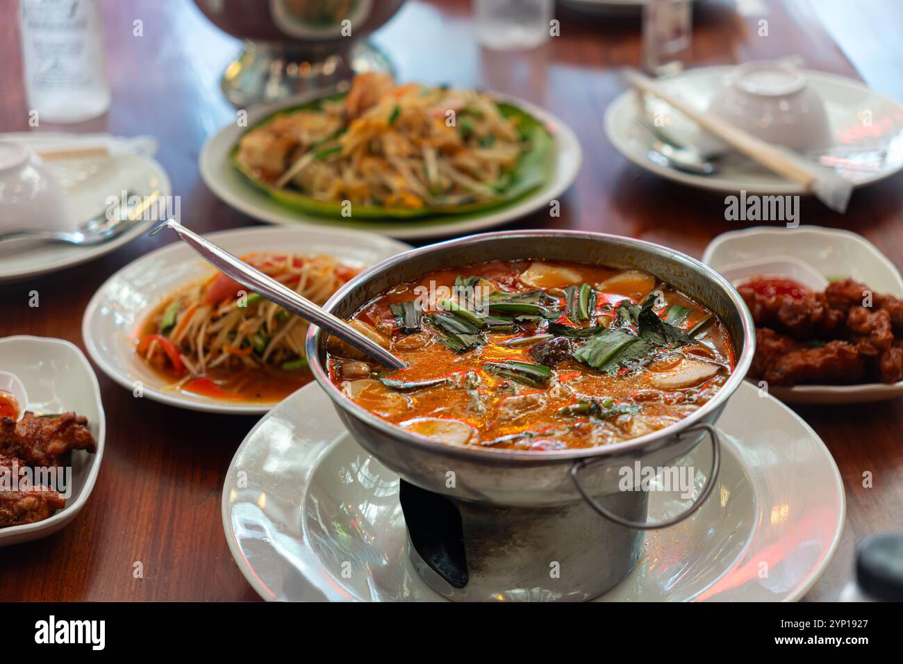 Tom Yum prawn and Squid in Thai Style, spicy prawn soup in the hot pot. traditional Thai dishes ...