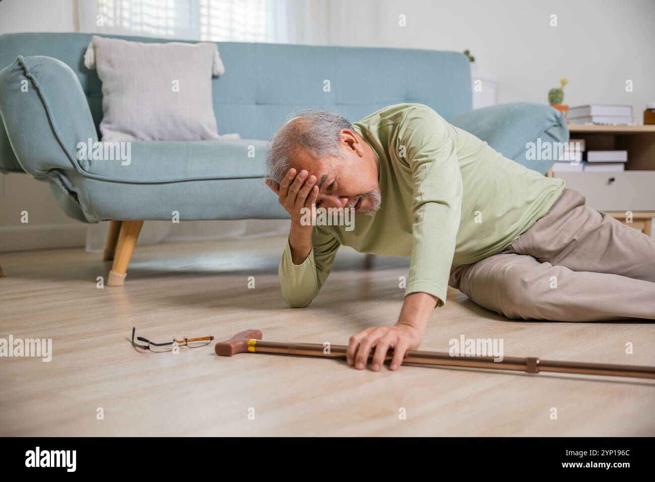 Sick senior old man falling down lying on floor because stumbled at ...