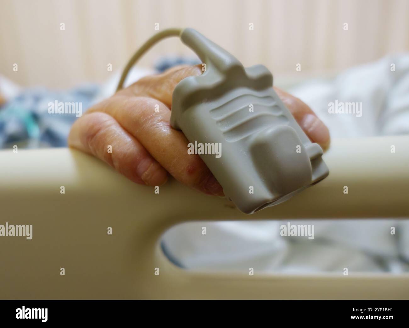 Hand of a senior woman wearing a pulse oximeter on middle finger ...