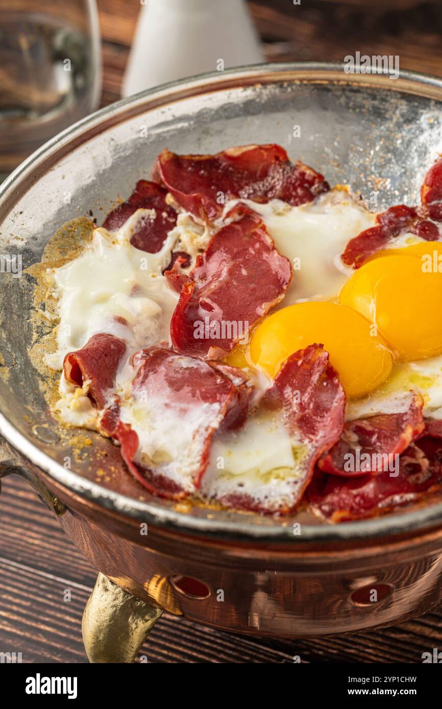 Traditional Turkish breakfast eggs with fried pastrami or bacon ...