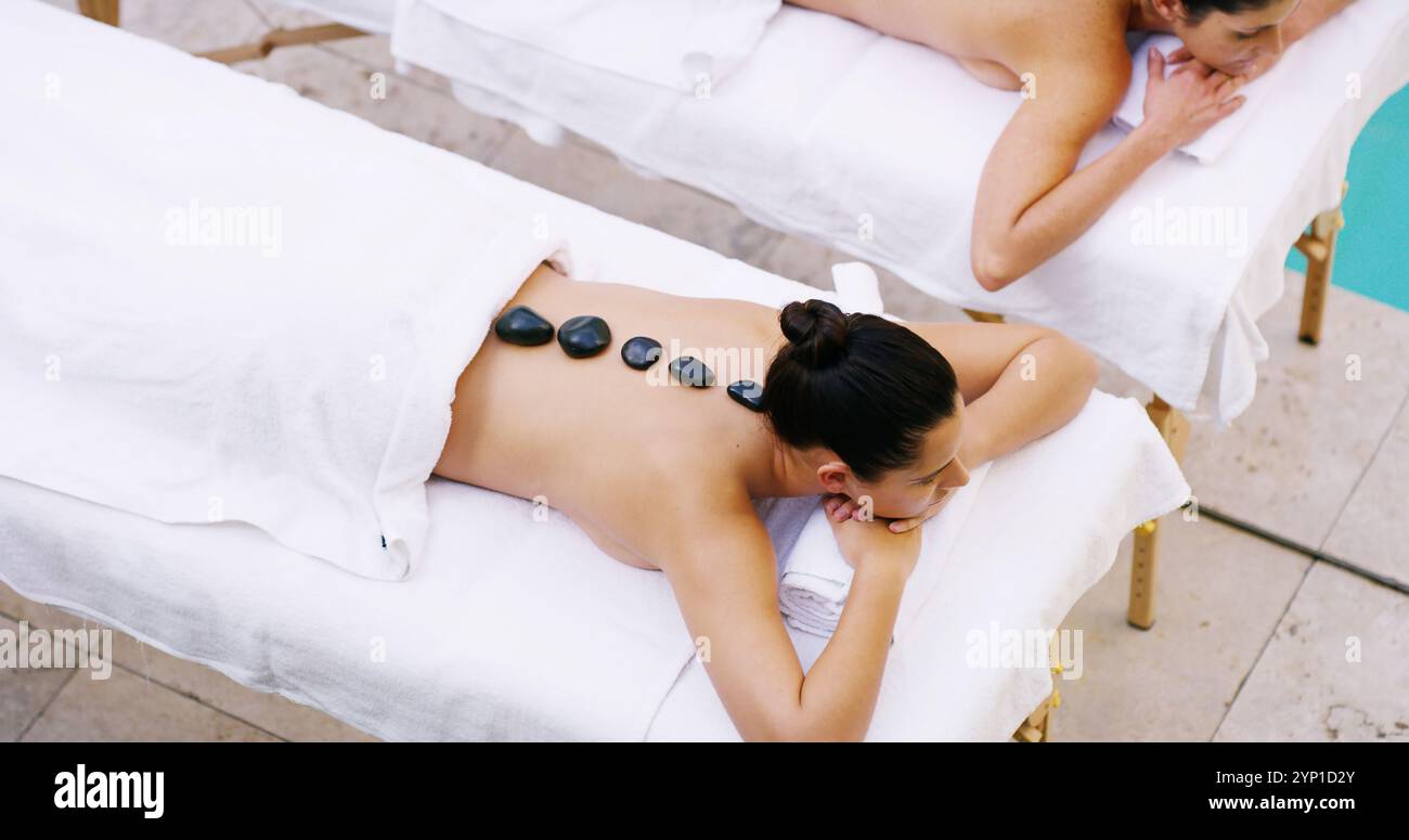 Women Relax And Above With Hot Stones At Spa For Massage Stress