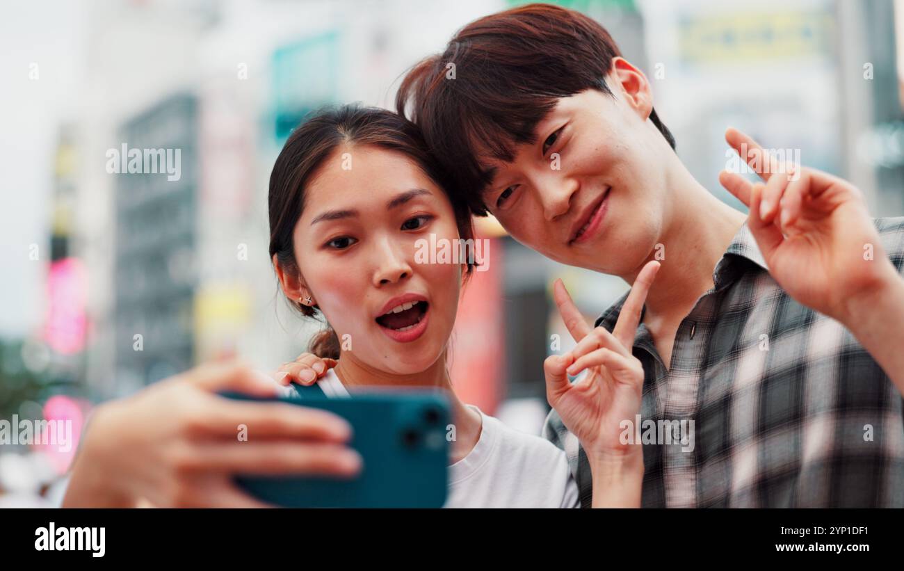 City, peace sign and selfie with couple on street together in Japan for ...