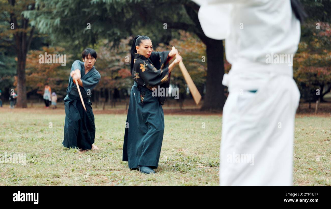 Sword, martial arts and people in outdoor class together for aikido ...