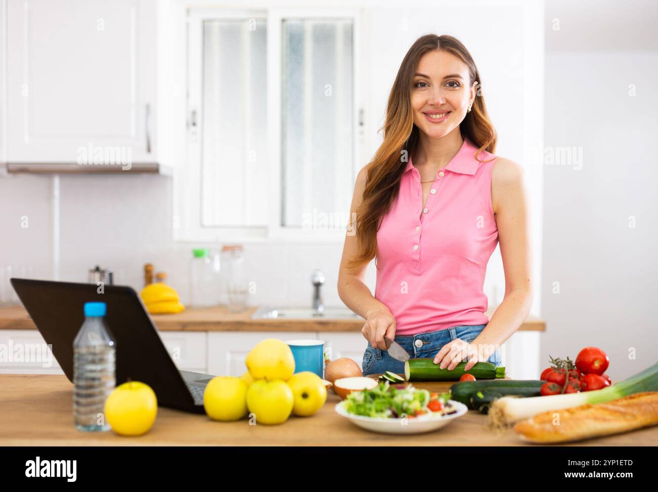 Woman cooking salad recipe from the Internet Stock Photo - Alamy
