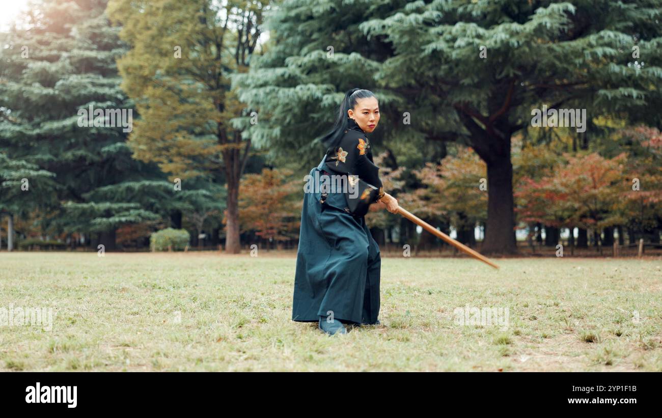 Nature, fight and Asian woman with bamboo sword in park for martial ...