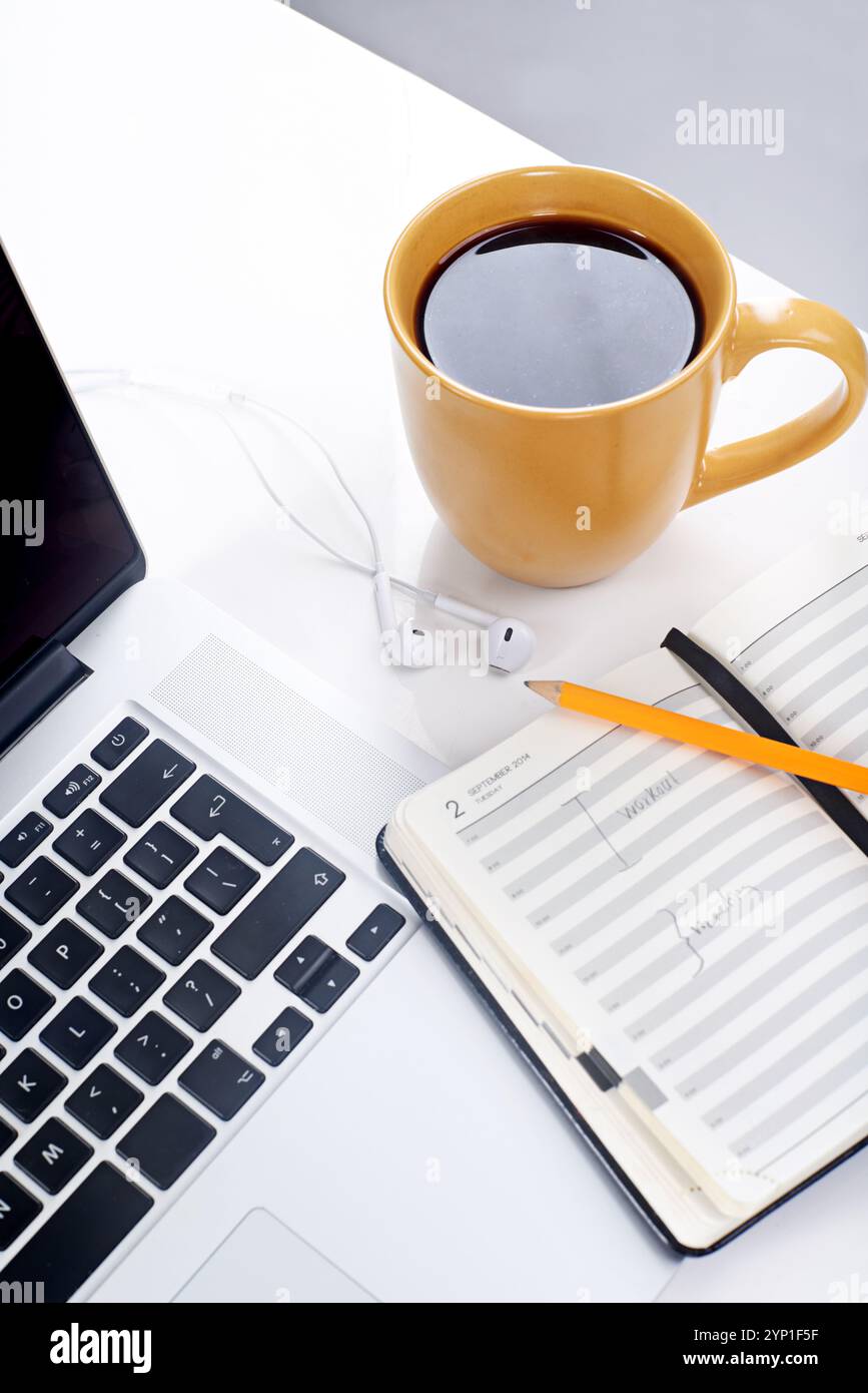 Closeup, laptop and coffee with notebook, internet and network with ...