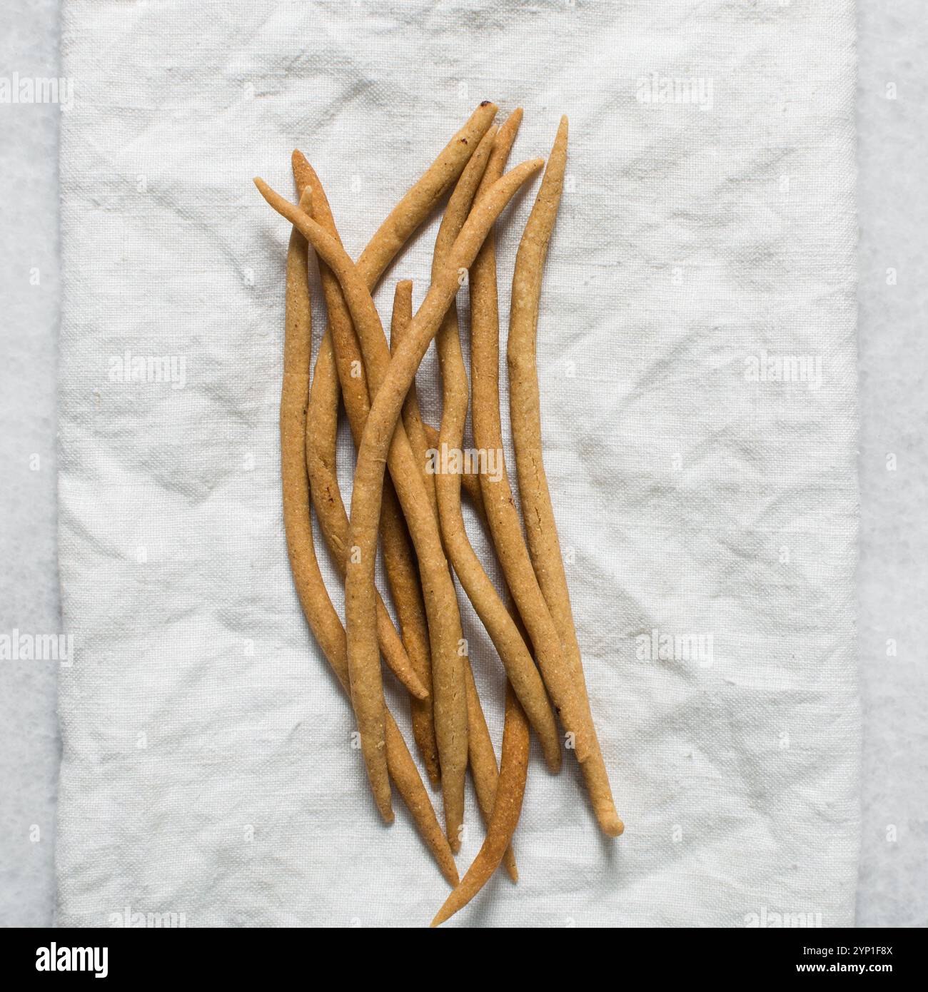 Top view of fried corn stick snack on a white granite countertop ...