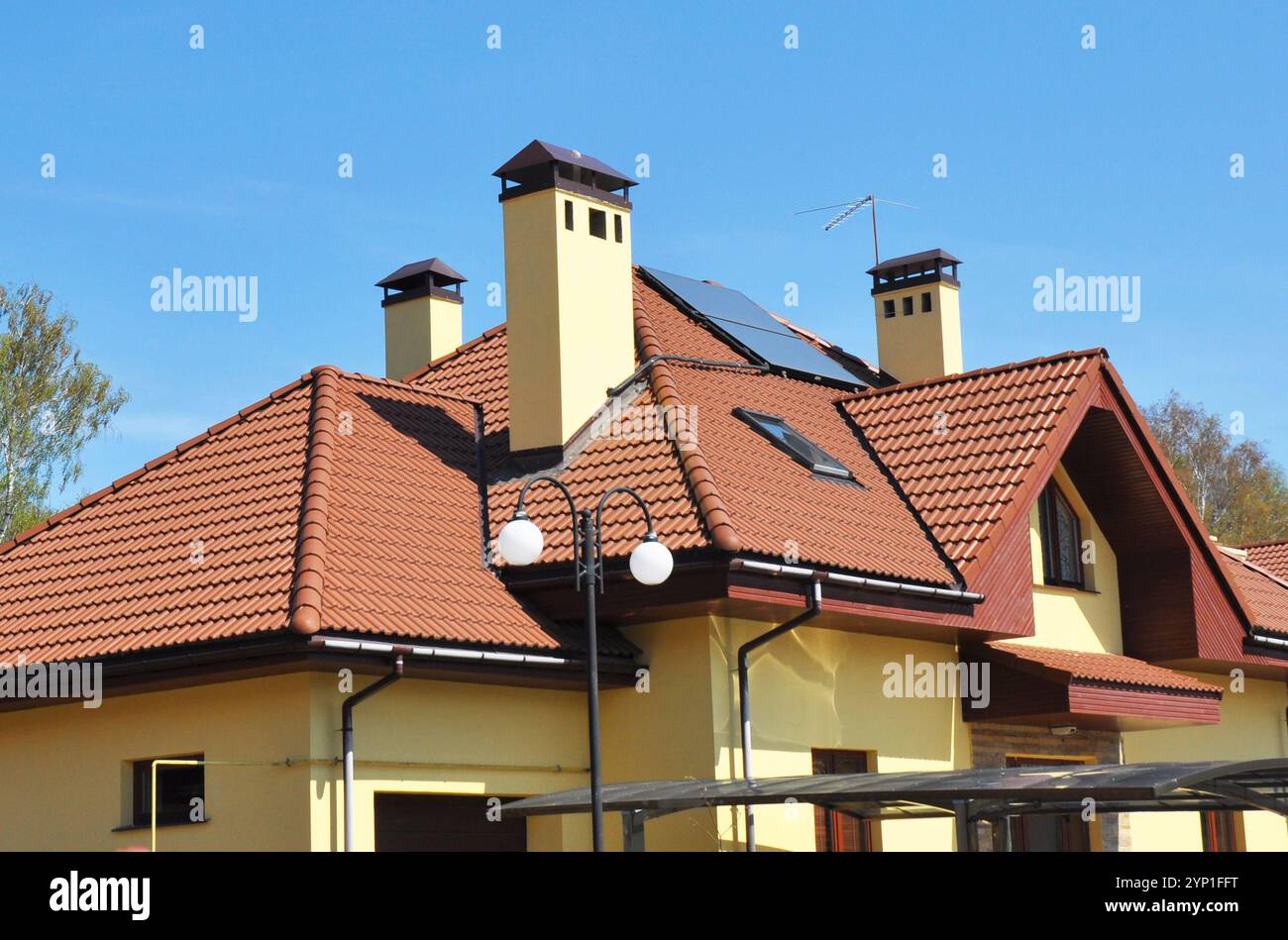 Modern house attic roof with skylight windows, roof gutter, chimneys ...