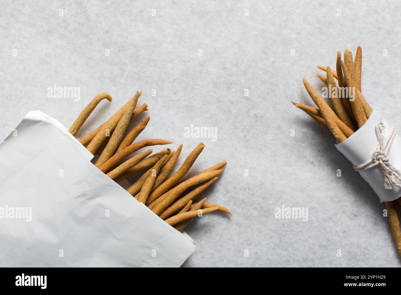Top view of fried corn stick snack on a white granite countertop ...