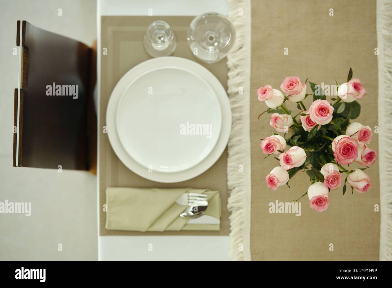 Dining Table Setup with Plate and Pink Roses Arrangement Stock Photo ...