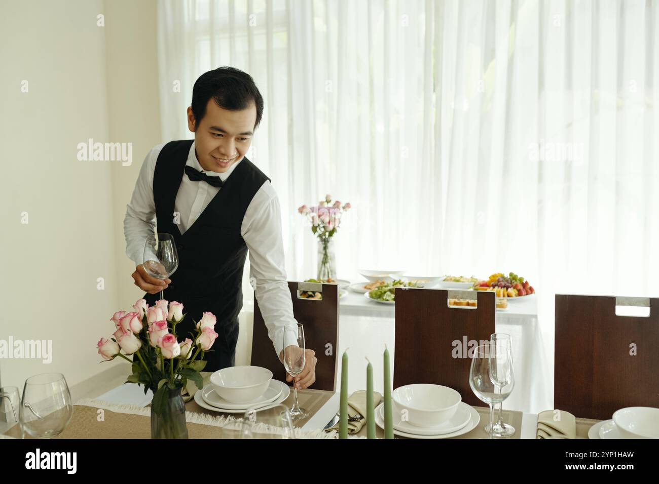 Smiling Waiter Preparing Elegant Dining Table Setup Stock Photo - Alamy