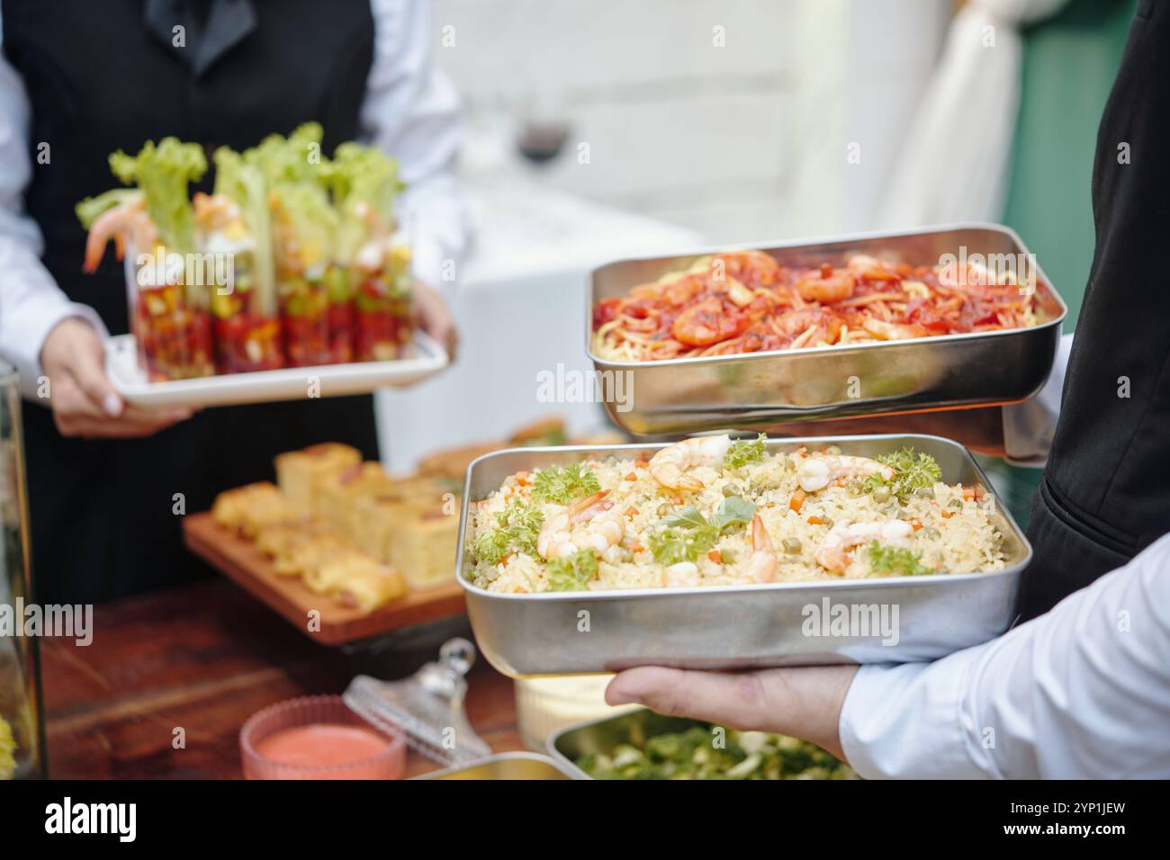 Preparing and Presenting Assorted Buffet Dishes Stock Photo - Alamy